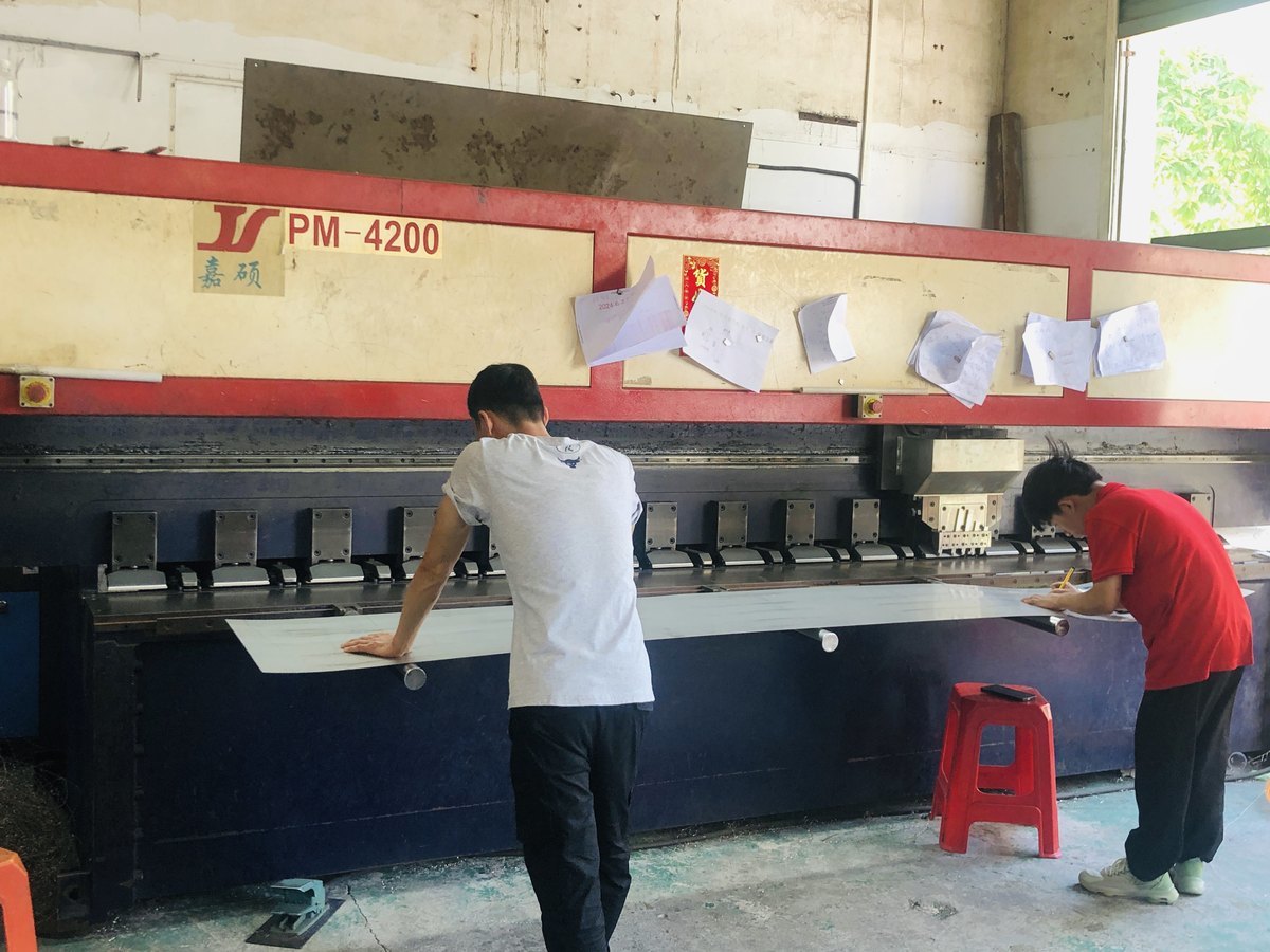 Metal sheet forming and fabrication workshop with industrial metalworking equipment